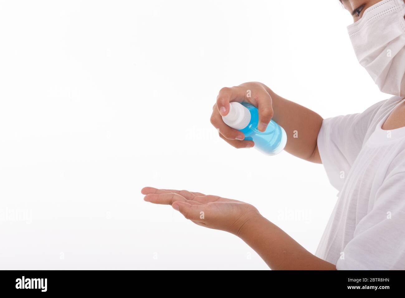 little girl using alcohol gel for cleaning hands.on white background ...