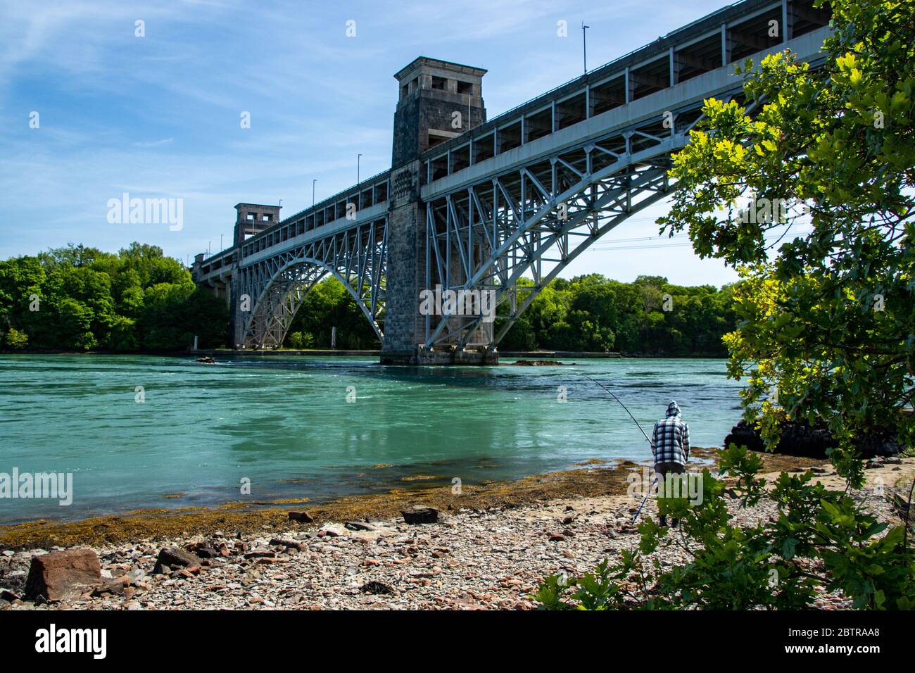 Fishing on the Anglesey shores of the Menai Strait with views of the ...
