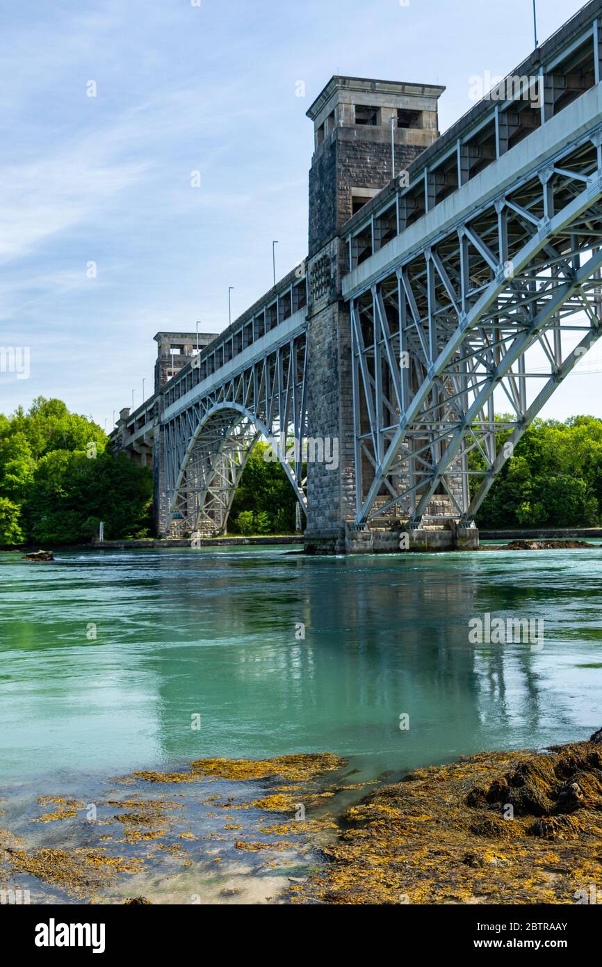 The Britannia Bridge and Menai Strait from the shores of Anglesey in ...