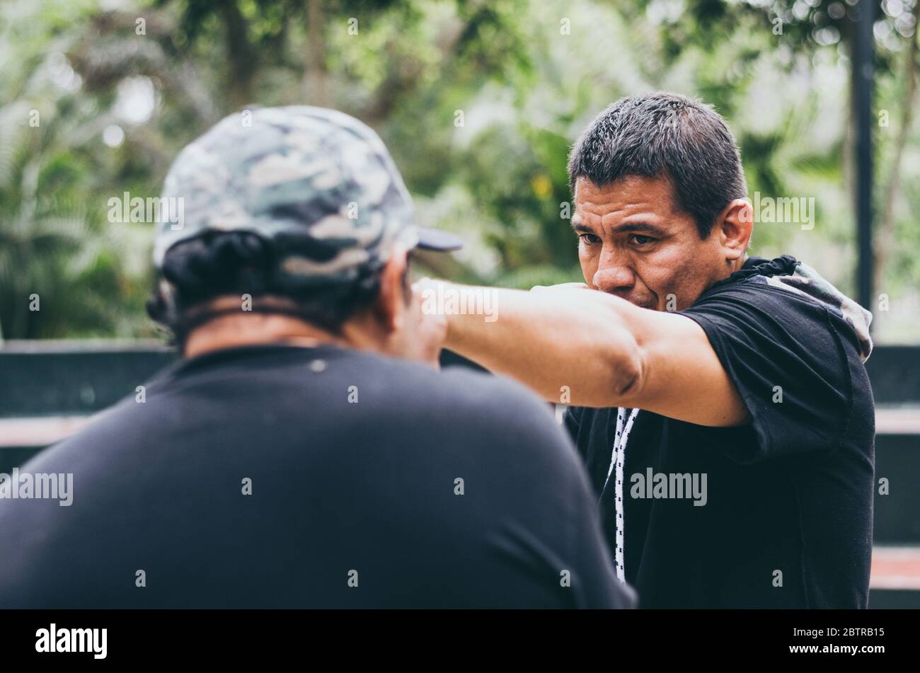 boxing outdoor workout with trainer, punching exercises with personal ...