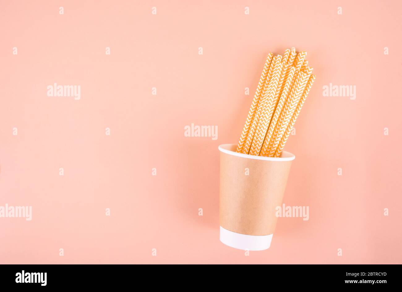 Paper glass with drinking tubes. Eco utensils on a light background ...