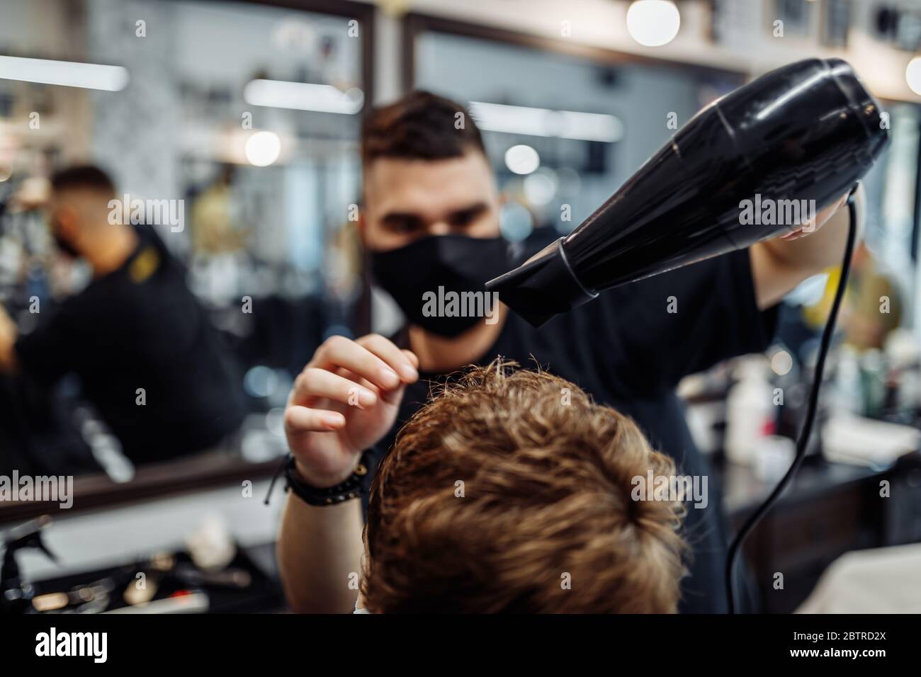 Styling men's hair. Barber make a stylish hairstyle Stock Photo - Alamy
