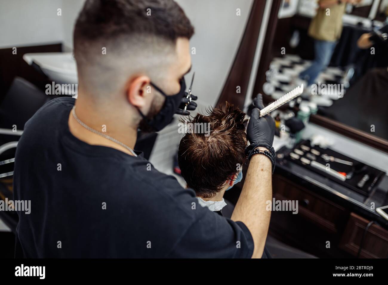 Creating a cool haircut and styling in a barbershop Stock Photo - Alamy