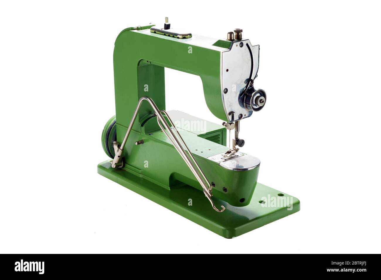 side view of an old vintage green sewing machine on white background ...