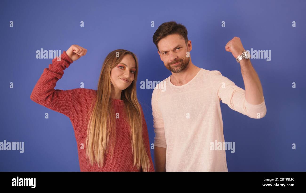Young couple showing their strength. Never surrender concept Stock ...