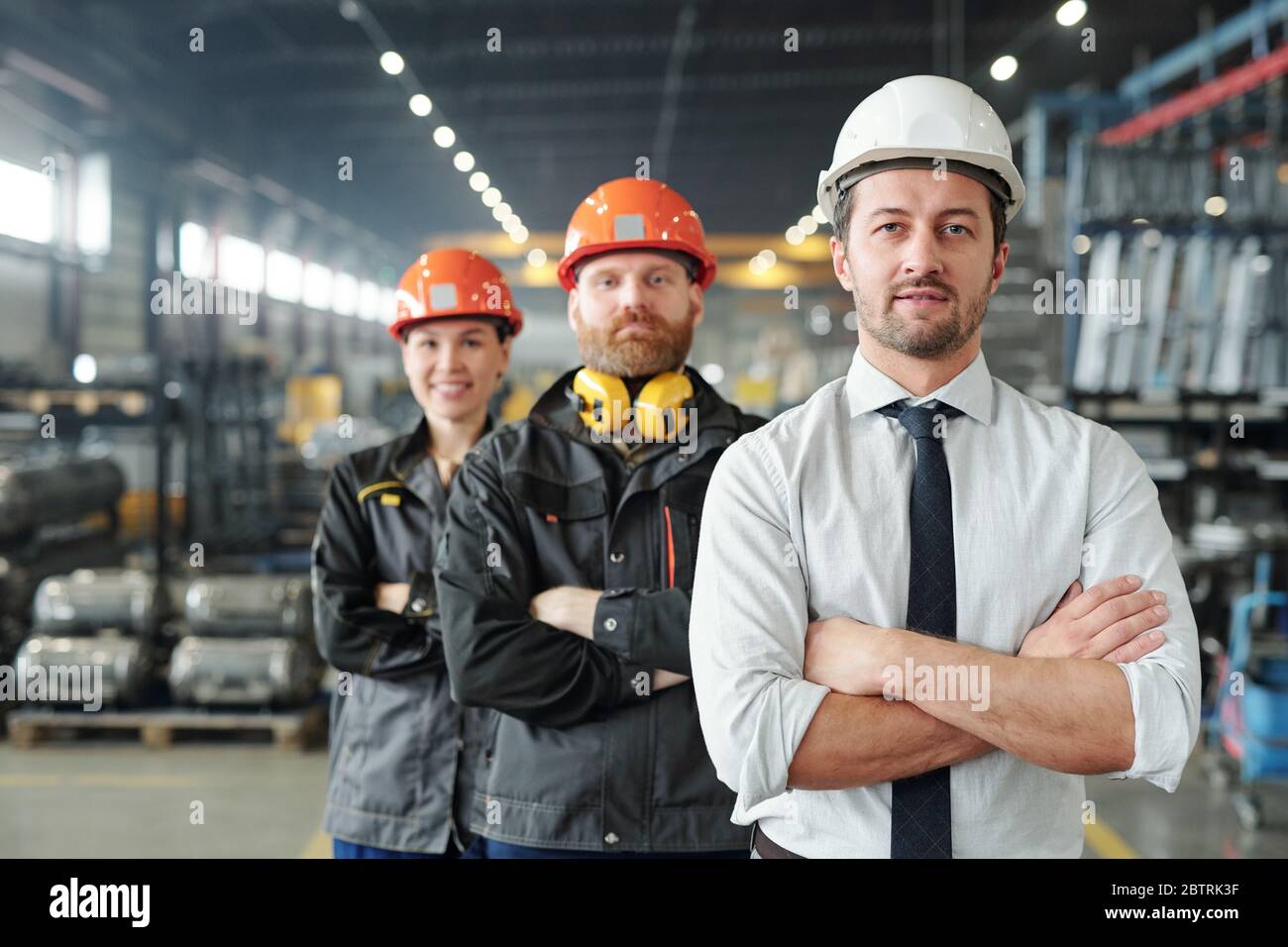 Portrait warehouse team standing arms hi-res stock photography and ...