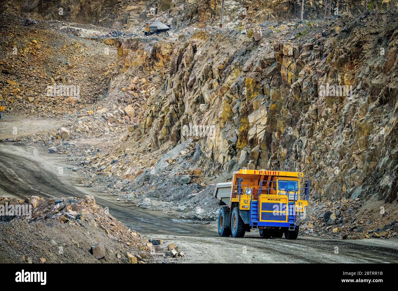 Zhodzina, Belarus - August 16, 2013: Granite mining in Quarry Trucks ...