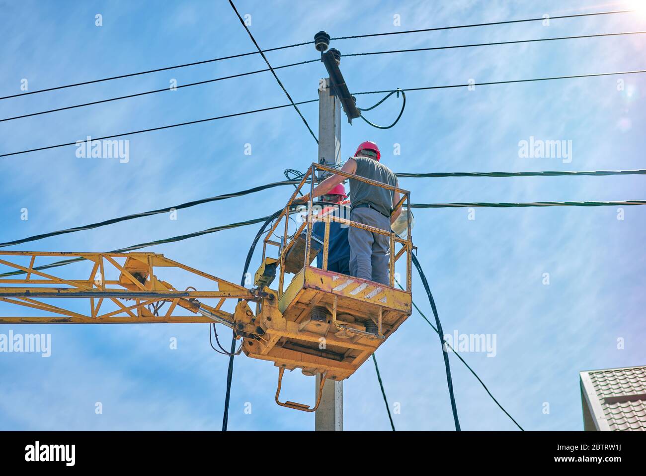 electrician in a car tower to repair power lines Stock Photo - Alamy