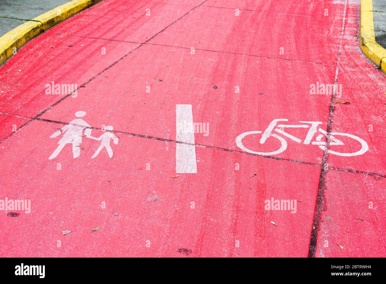 Footpath and bike path divided by a white line Stock Photo - Alamy