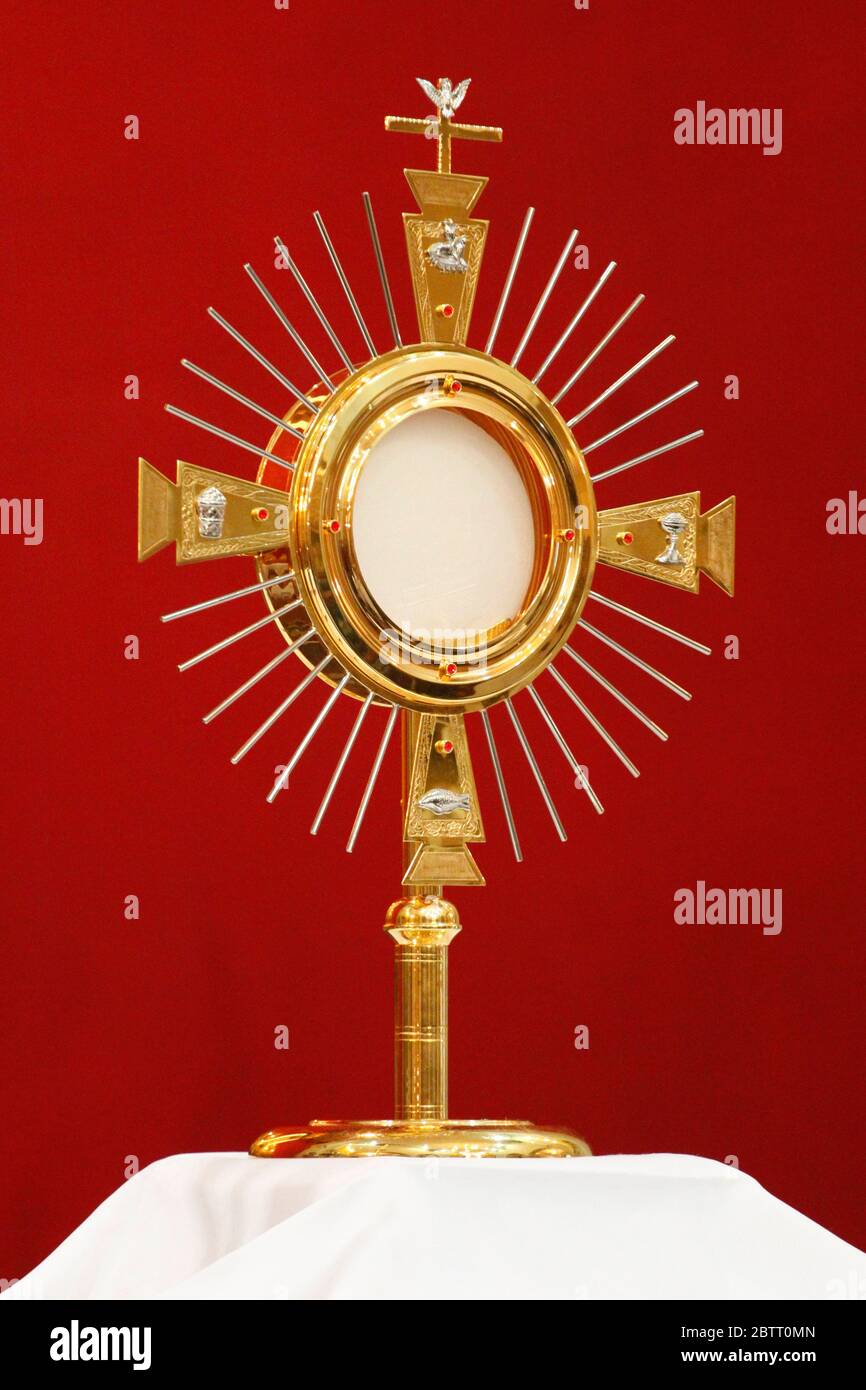 Ostensory for worship at a Catholic church ceremony with red scenery ...