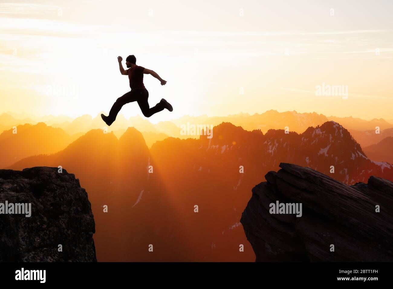 Adventure and Challenge Concept Composite of Man Jumping Across a Gap ...