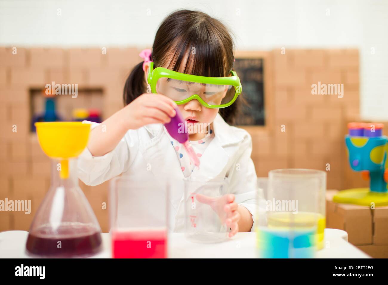 toddler girl pretend play scientist role for homeschooling Stock Photo ...