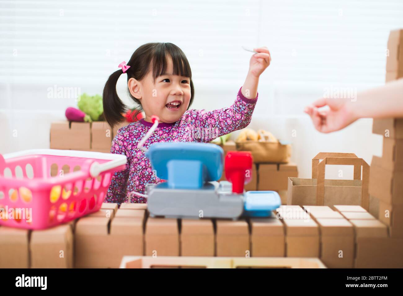 toddler girl pretend play sweet shop keeper at home Stock Photo - Alamy