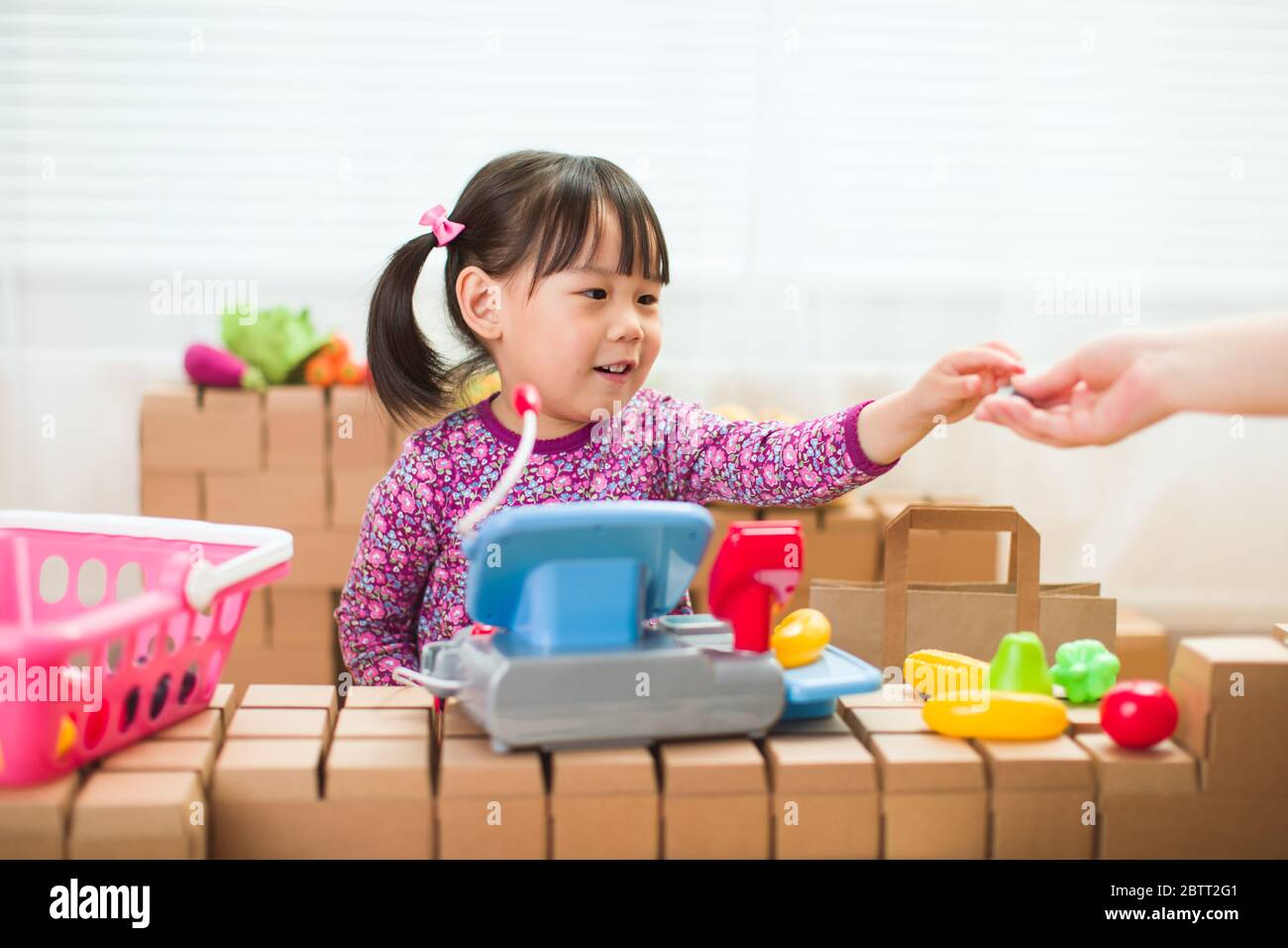 toddler girl pretend play sweet shop keeper at home Stock Photo - Alamy