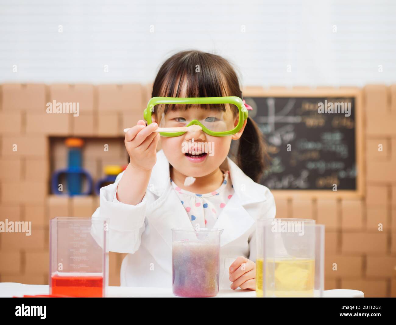 toddler girl pretend play scientist role for homeschooling Stock Photo ...