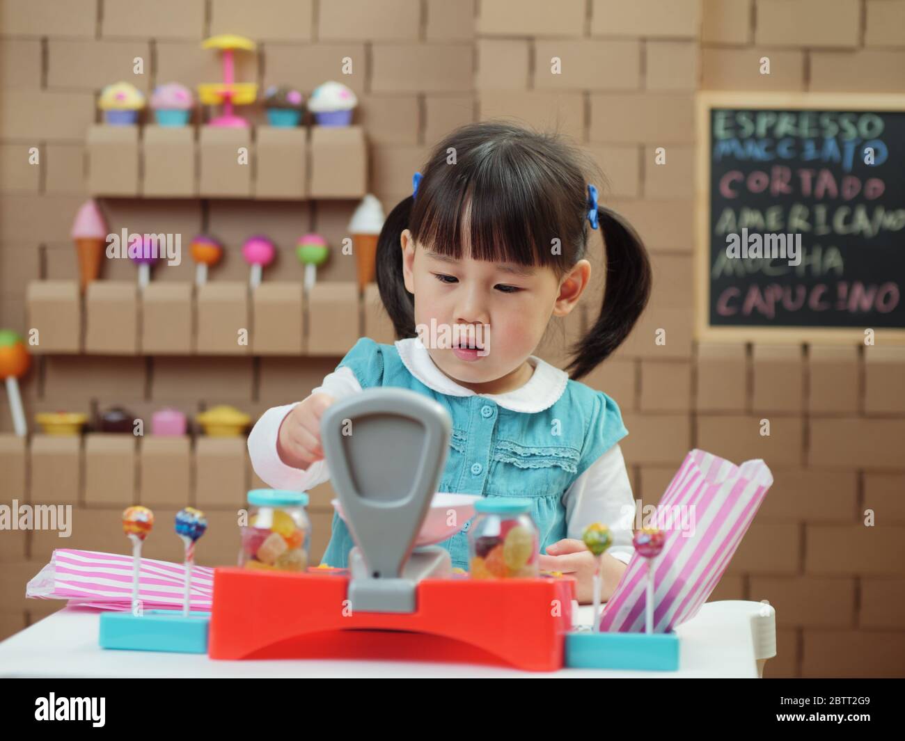 toddler girl pretend play sweet shop keeper at home Stock Photo - Alamy