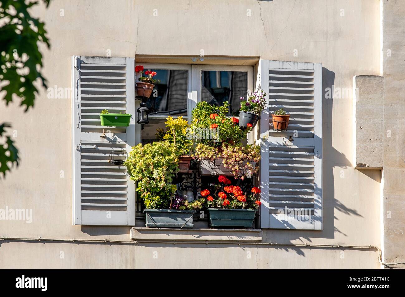 Paris, France - May 14, 2020: Window with flowers in a parisian house ...