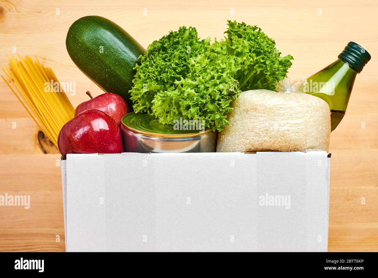 Close up white box with different healthy products on a wooden ...