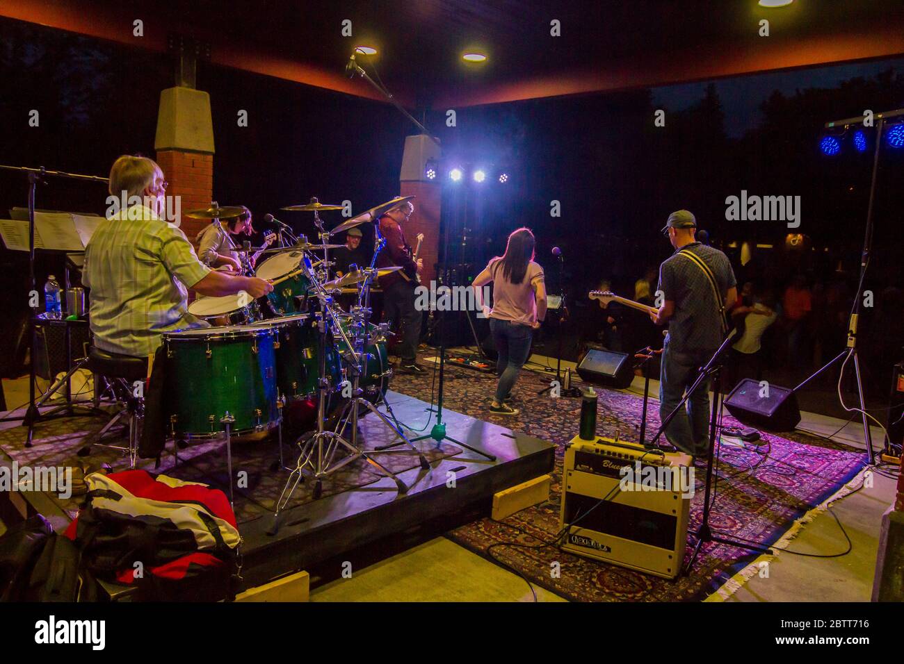 Rock band on stage, in concert, singer, bass guitar, lead guitar and ...