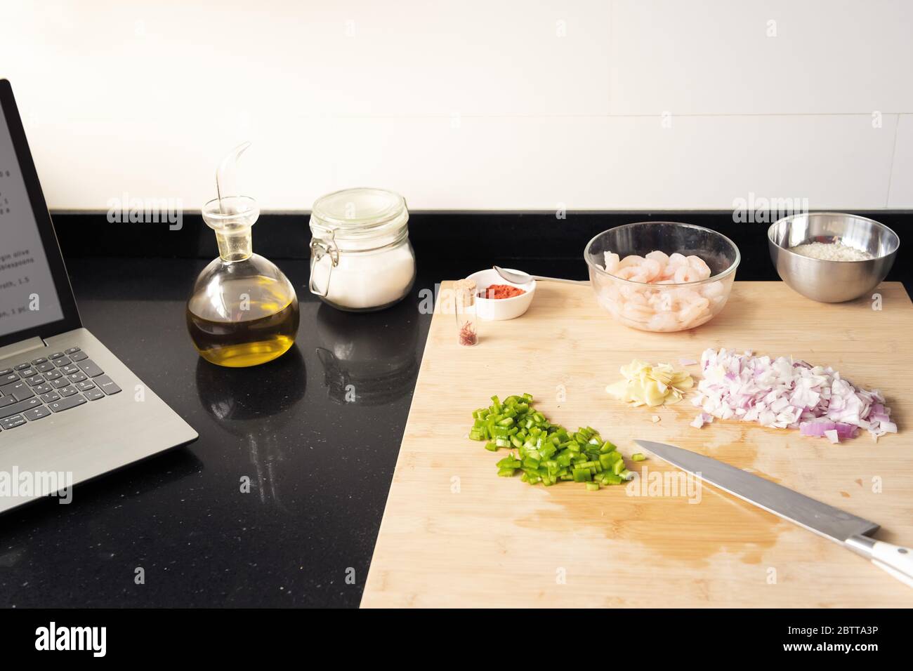 kitchen worktop with cutting board, ingredients and laptop, learning to ...