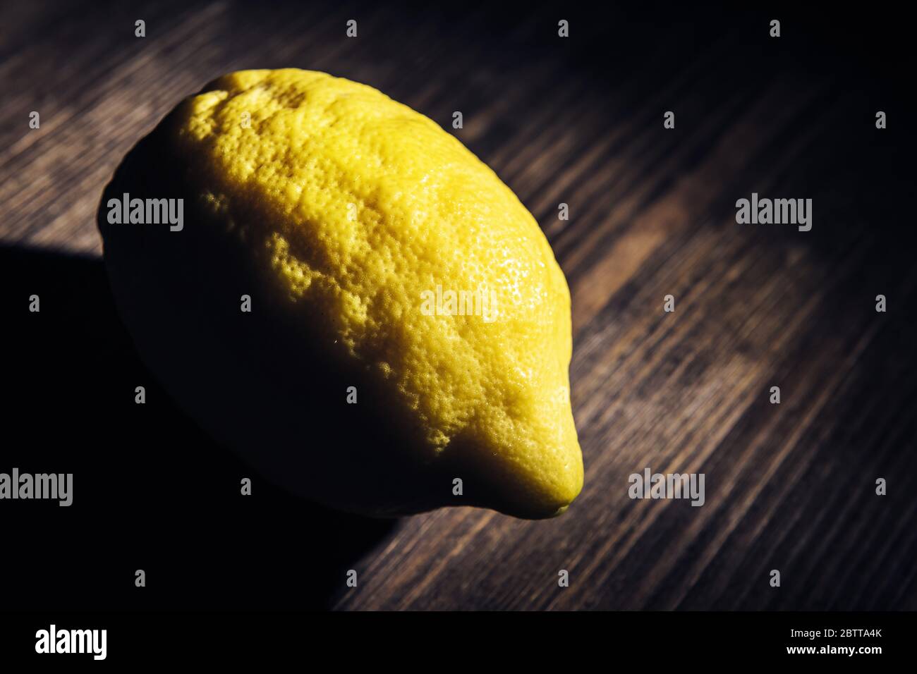 lemon on a dark wood rustic table, healthy eating concept, dark food ...