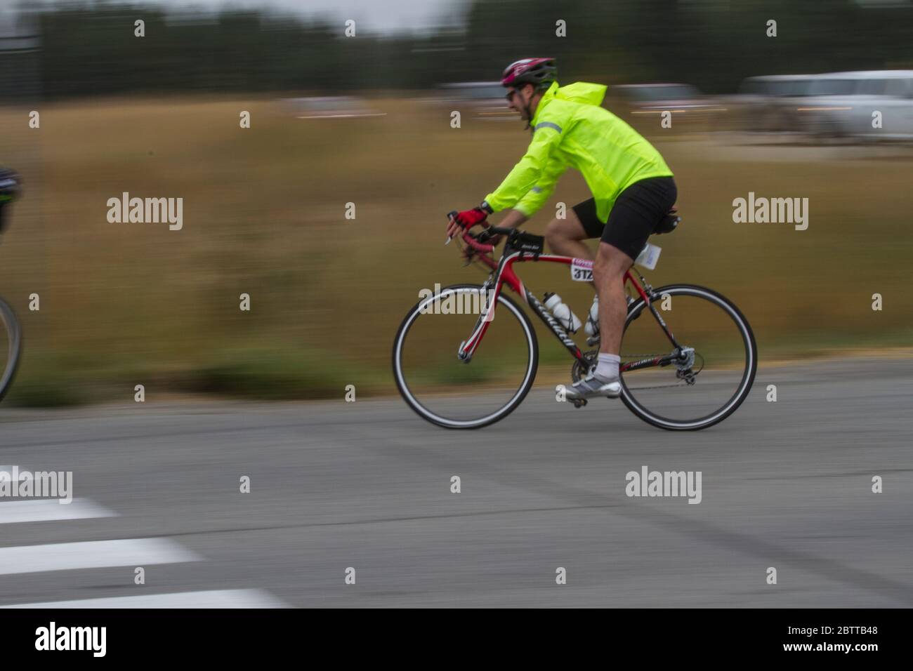 Scenic Bike Race, single rider, in full racing gear and uniform, taking ...