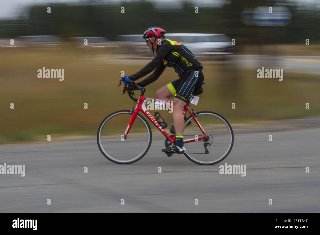 Scenic Bike Race, single rider, in full racing gear and uniform, taking ...