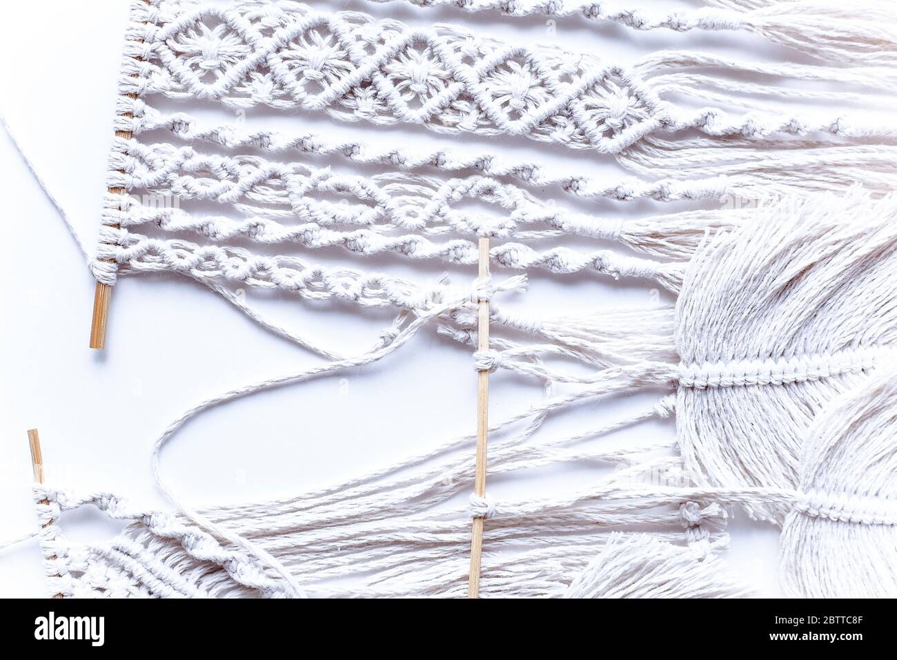 Handmade macrame braiding, background thread on a white background top ...
