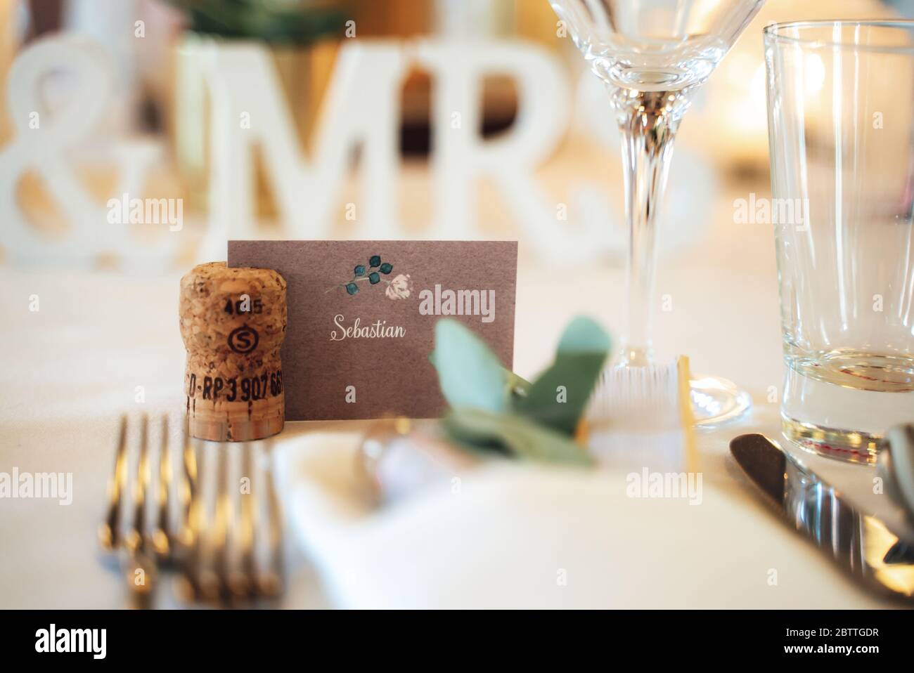 Closeup of label with name of guest in cork stand. Blurred elegant ...