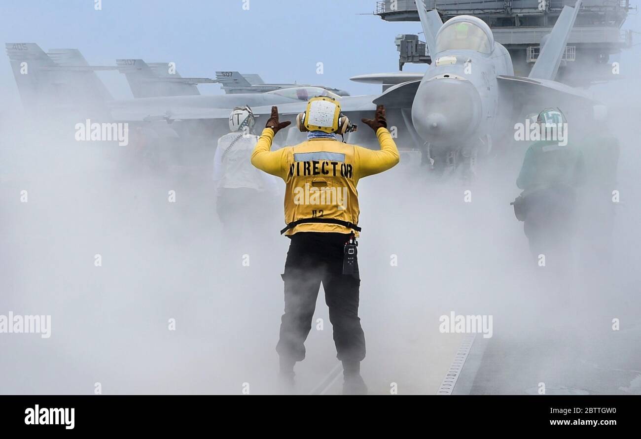 U.S. Navy Aviation Boatswain Mate Airman Thomas McLaughlin directs a F ...