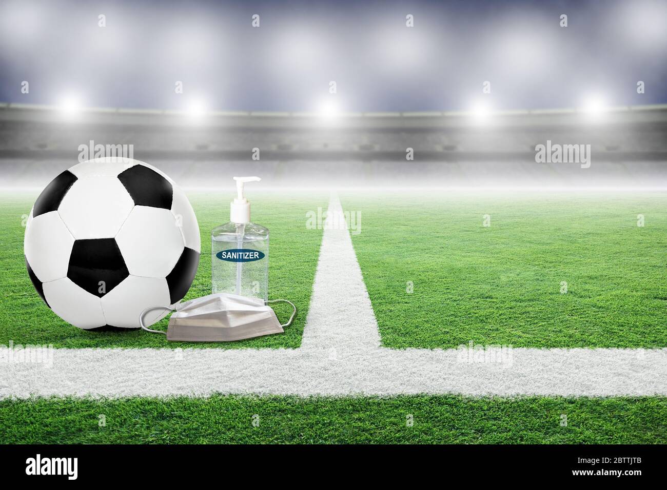 Soccer on field of an empty stadium with hand sanitizer and medical ...