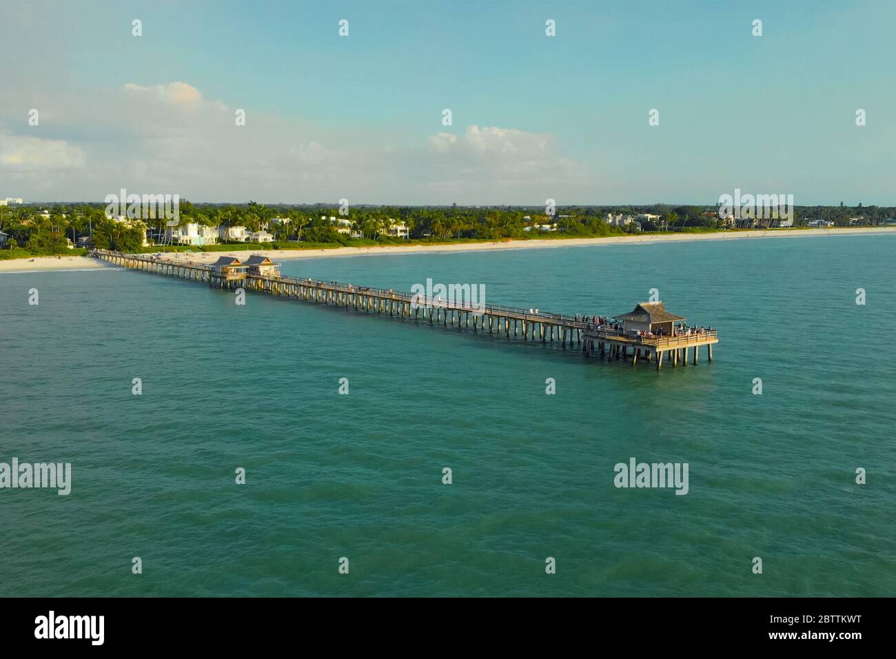 View from the ocean to the pier with tourists Stock Photo - Alamy