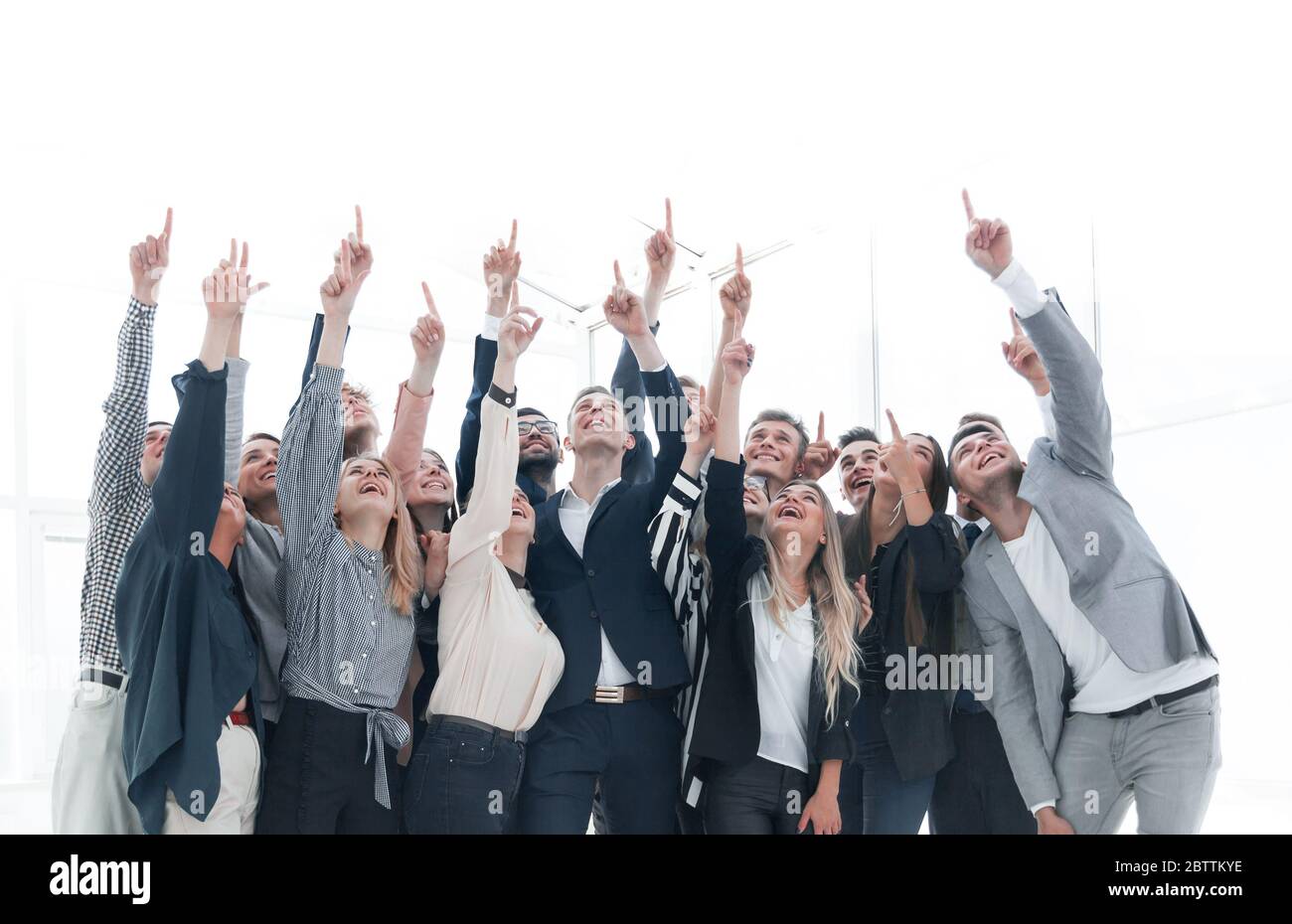 large group of happy business people pointing up Stock Photo - Alamy