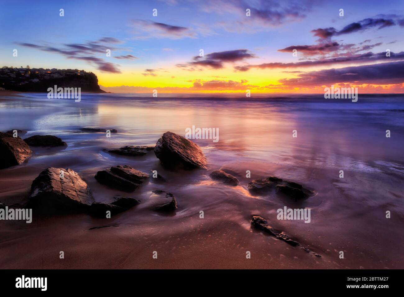 Round sandstone rocks standing off sandy Bungan beach of Sydney ...