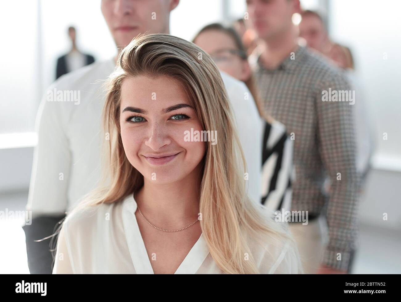 young woman standing first in a row of her colleagues Stock Photo - Alamy