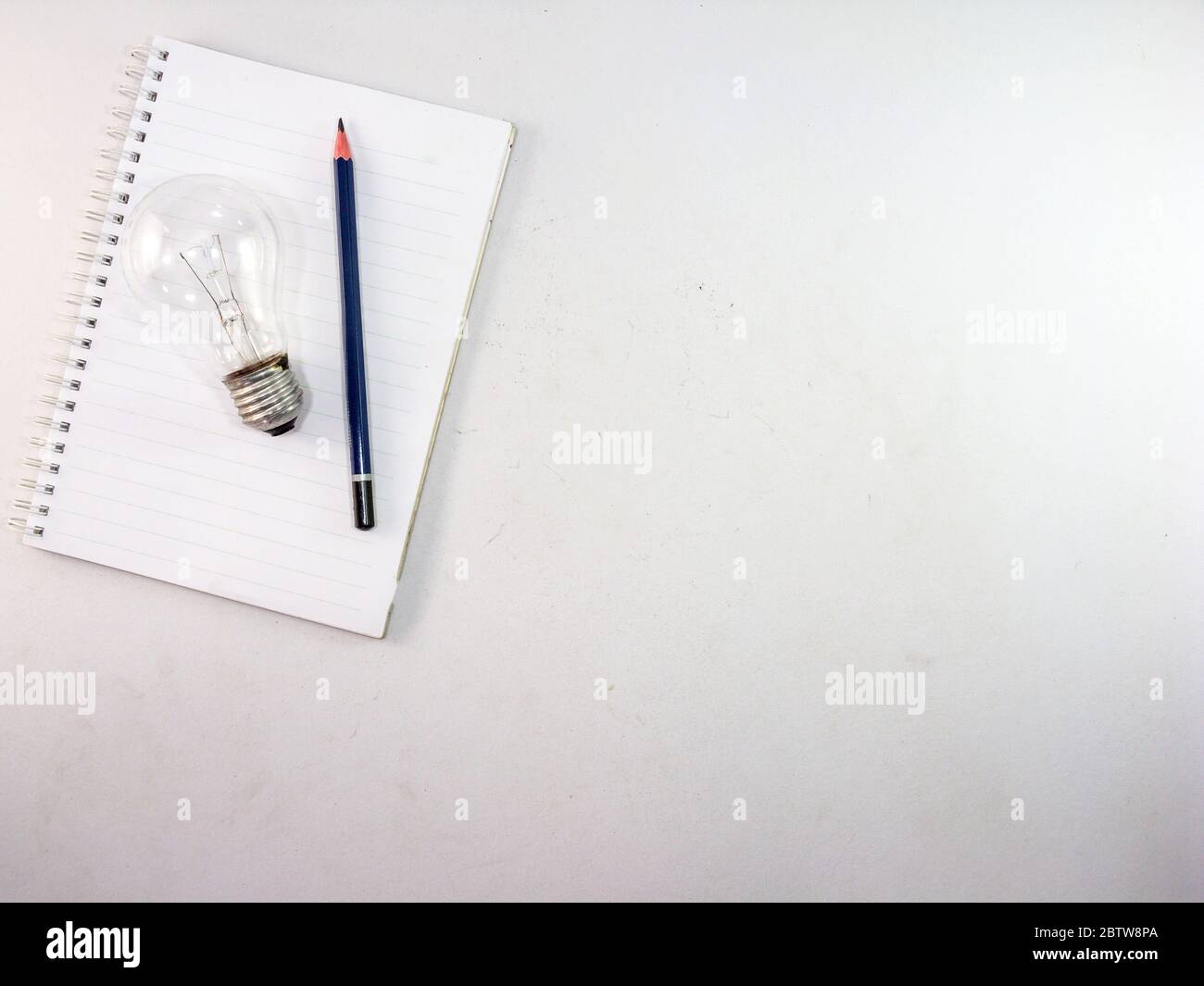 Light bulb and notebook with pencil On a white background , business ...