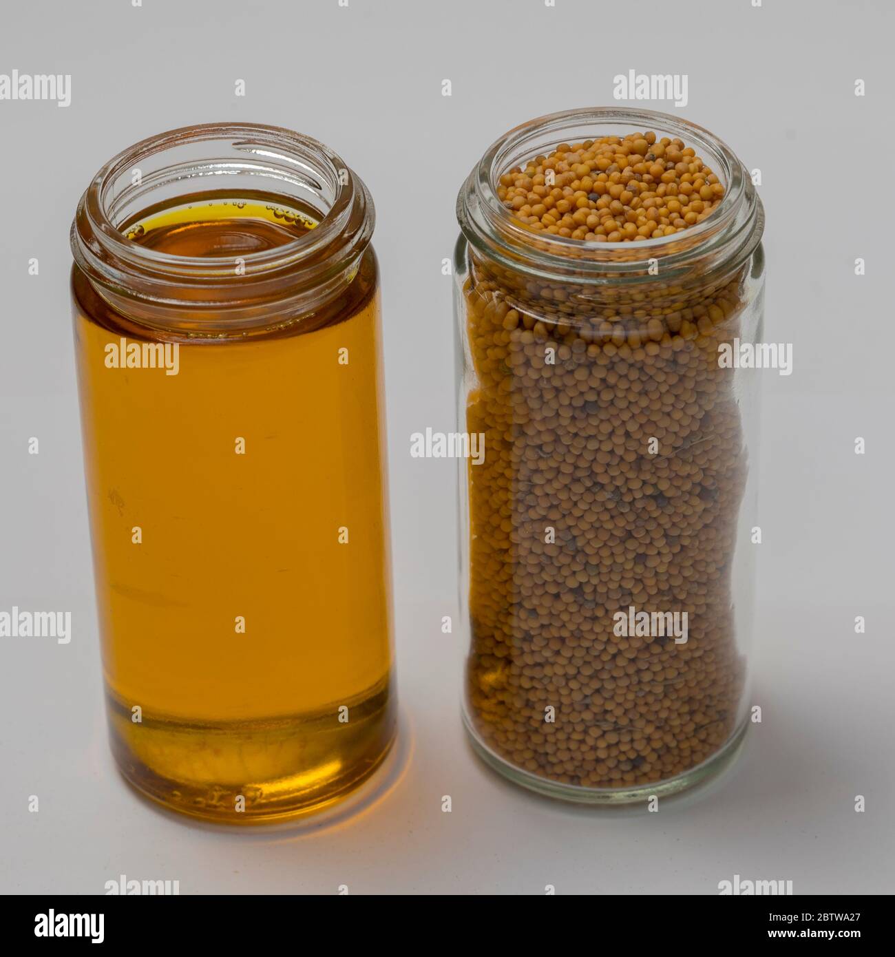 Close-up view of raw mustard and mustard oil on white background Stock ...