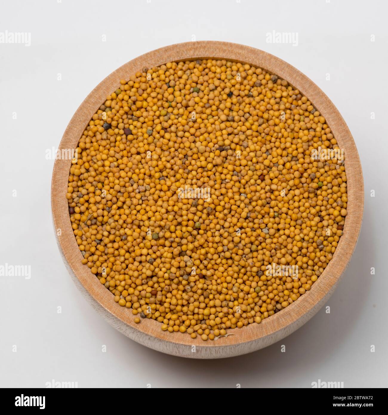 Close-up view of raw mustard seeds on white background Stock Photo - Alamy