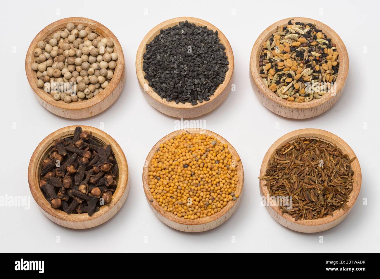 Different type of spices in small wooden bowls on white Background ...