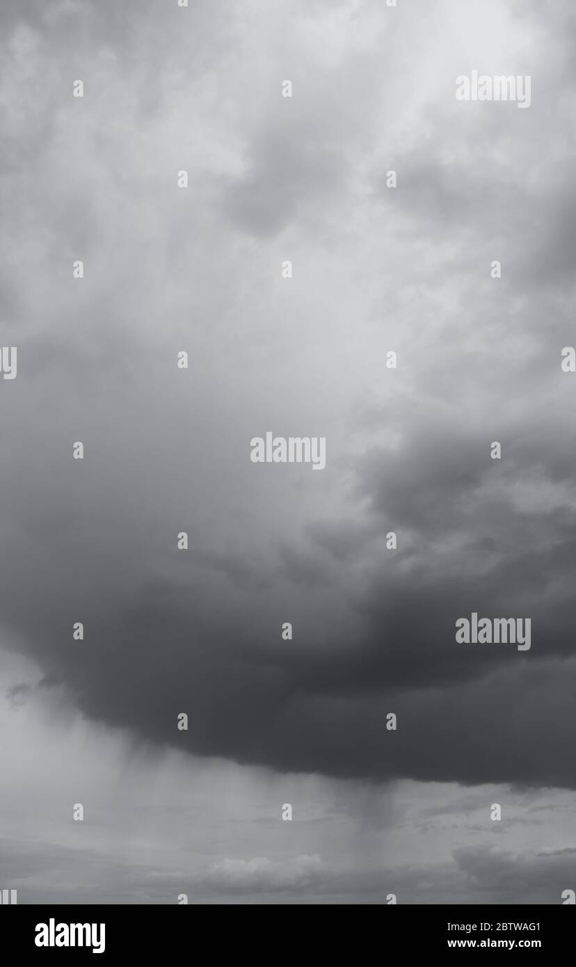 Vertical photo of rain clouds over horizon. Dark cloudy stormy sky with ...