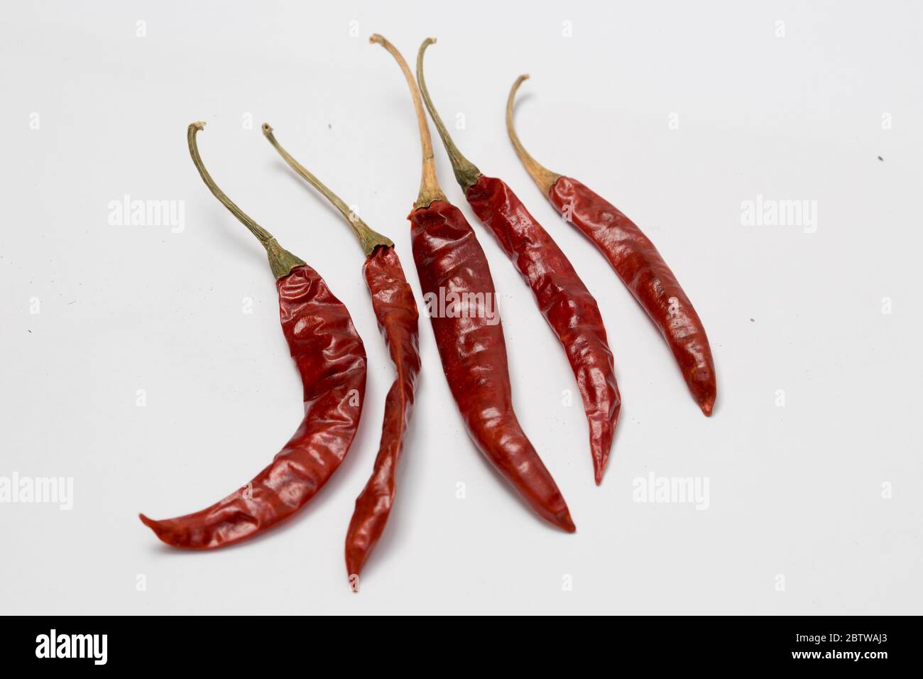 Close-up view of red chili on white background Stock Photo - Alamy