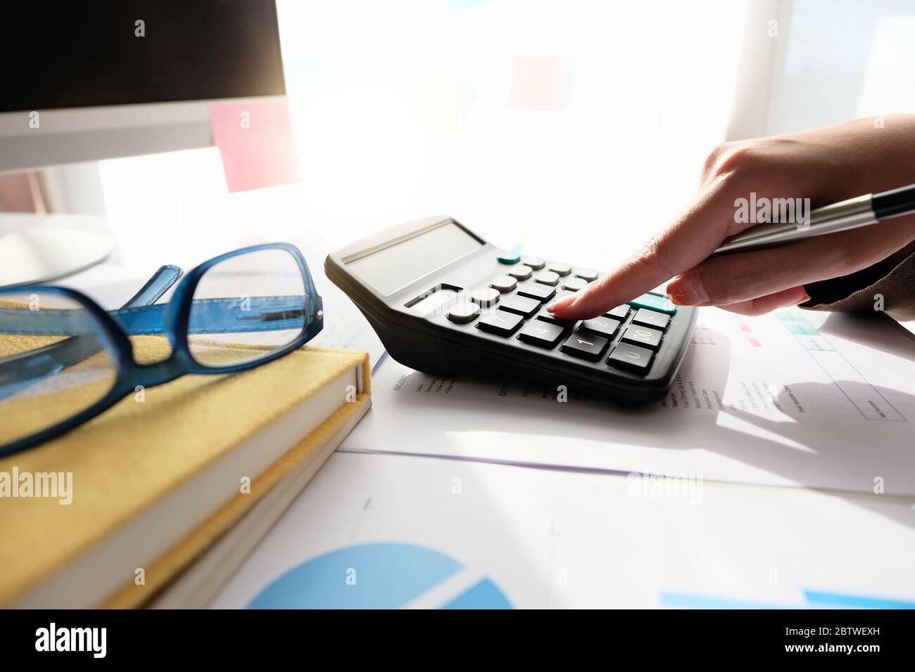 Close up Accountant using calculator for calculating financial expense ...