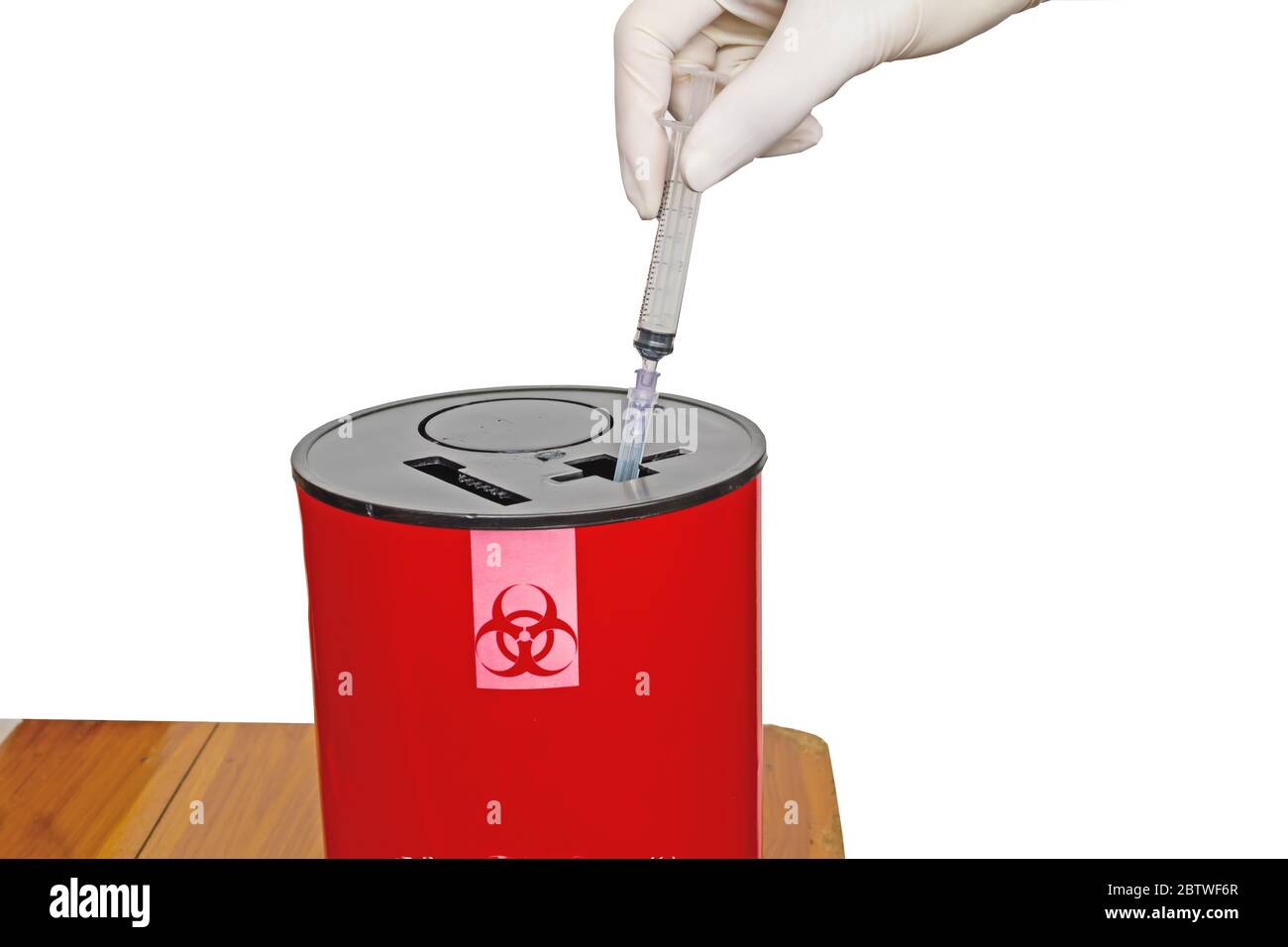 Doctor put syringe in red disposal boxes on white background Stock ...
