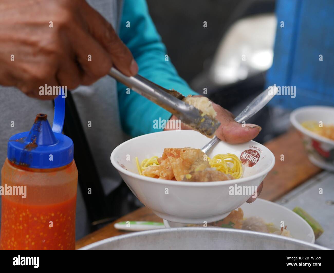 a mobile meatball seller is preparing a buyer's order Stock Photo - Alamy