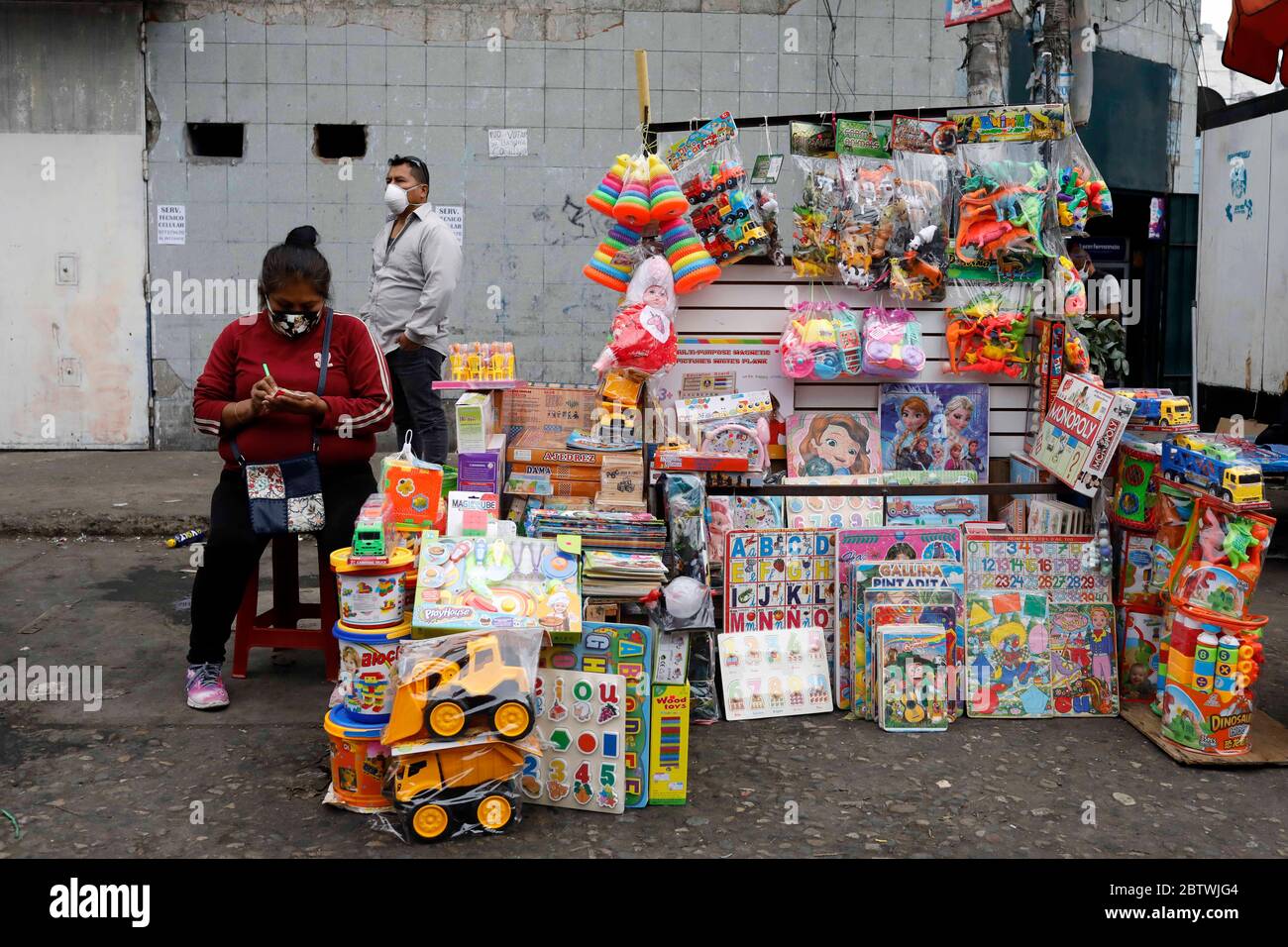 Lima, Peru. 26th May, 2020. Woman sells toys at a street during the ...