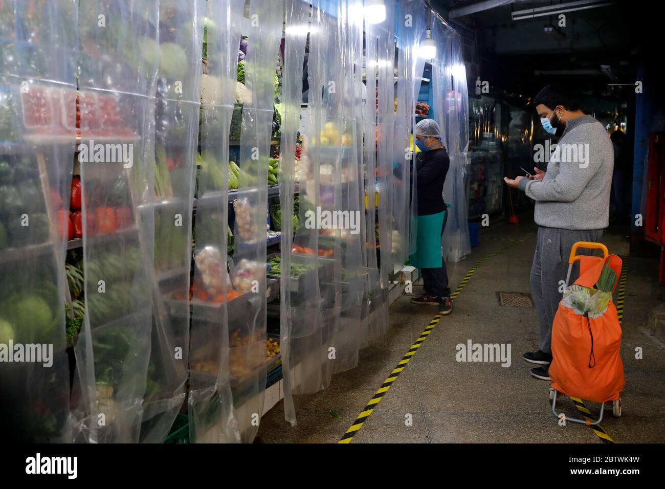 Lima, Peru. 27th May, 2020. A client buys fruit and vegetables at a ...