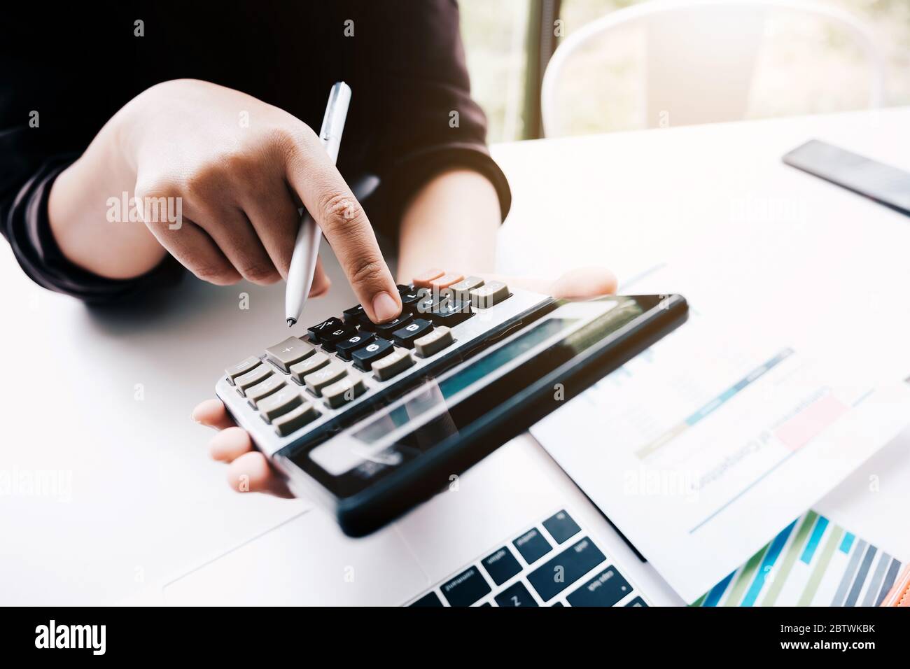 Close up Business woman using calculator for do math finance on wooden ...
