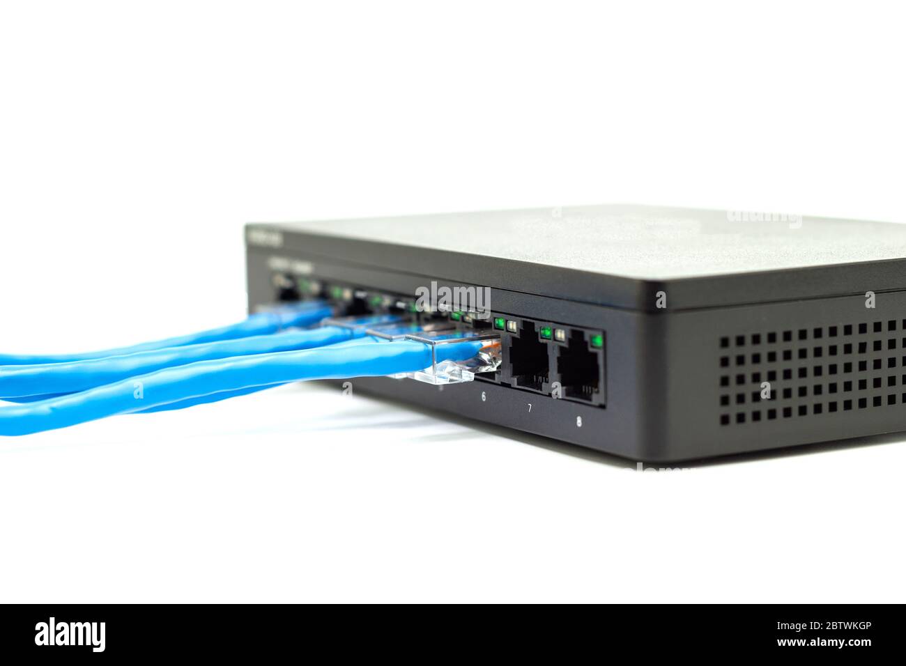 The blue network cables connect port switch on white table concept ...
