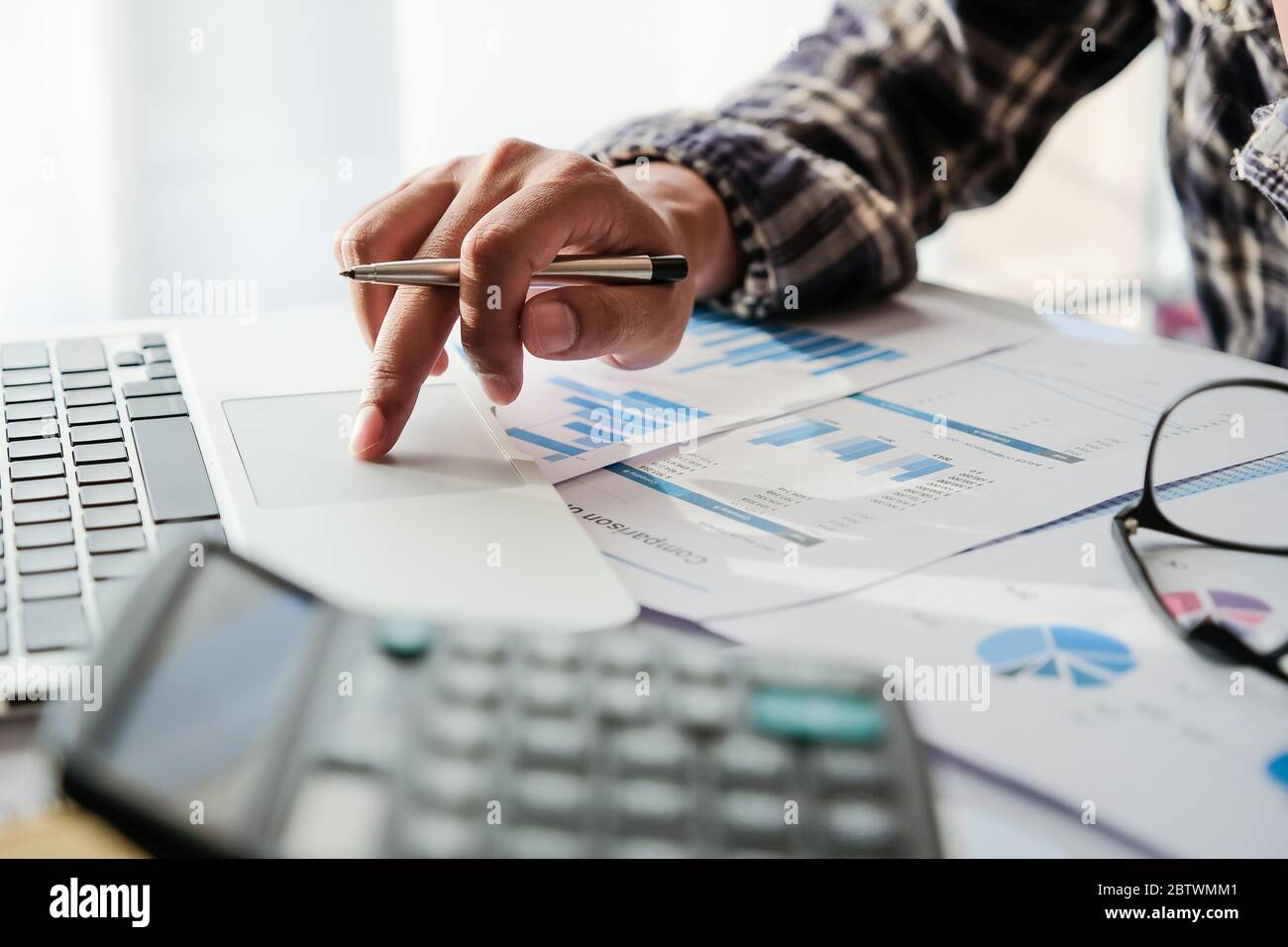 Business man or accountant working with laptop computer Stock Photo - Alamy