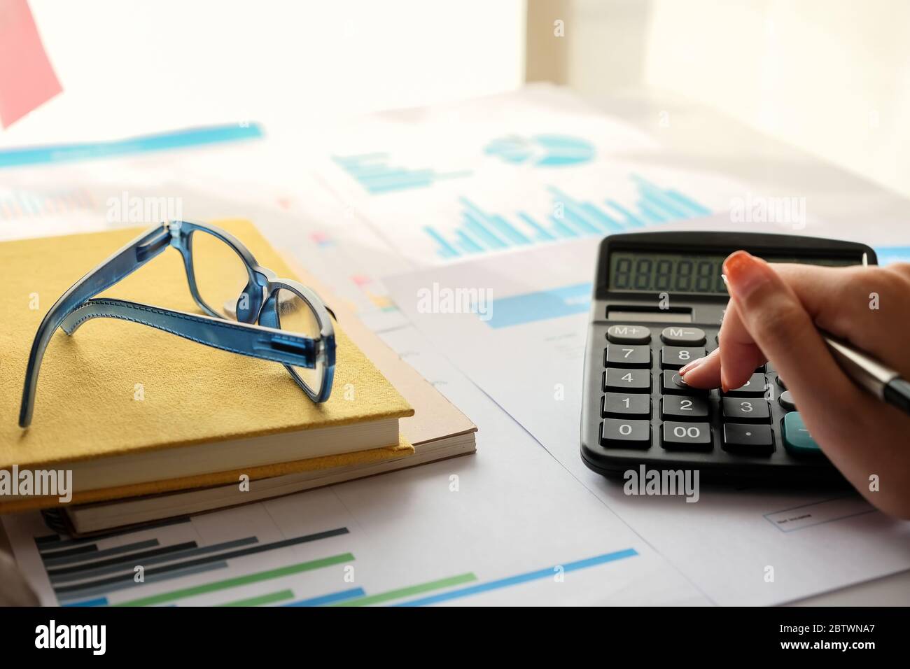 Close up Accountant using calculator for calculating financial expense ...